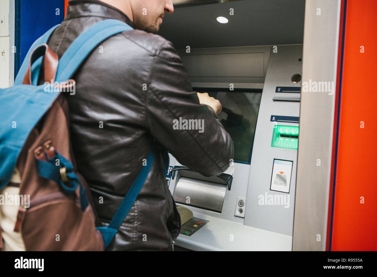 The tourist withdraws money from the ATM for further travel. Finance ...