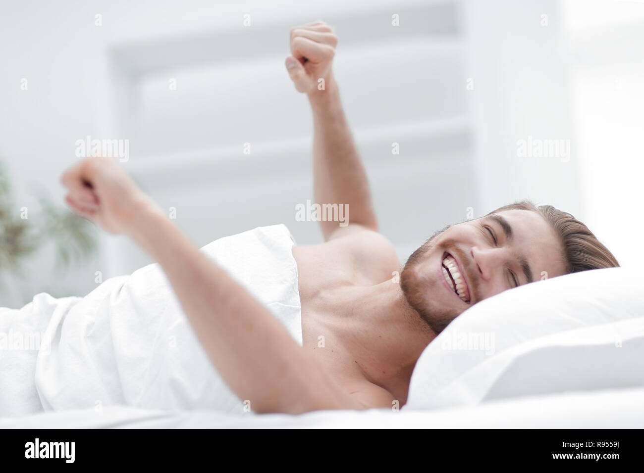 happy man waking up in a comfortable room Stock Photo - Alamy