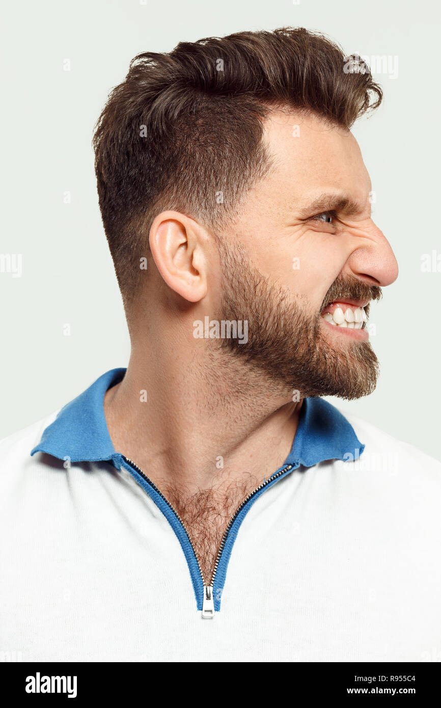 Screaming, hate, rage. Crying emotional angry man screaming on studio ...