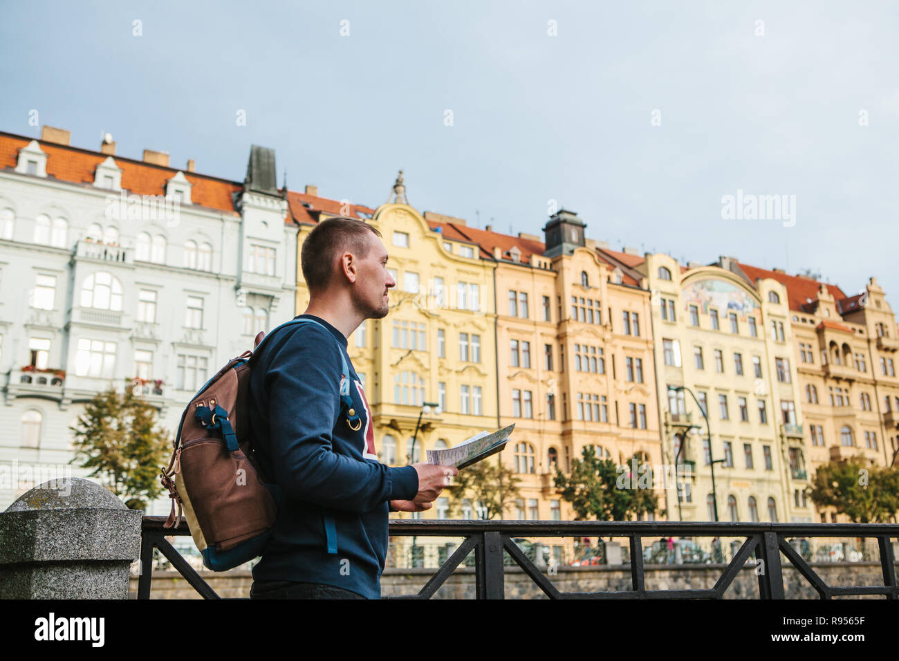 A tourist with a backpack in front of a beautiful old architecture in ...