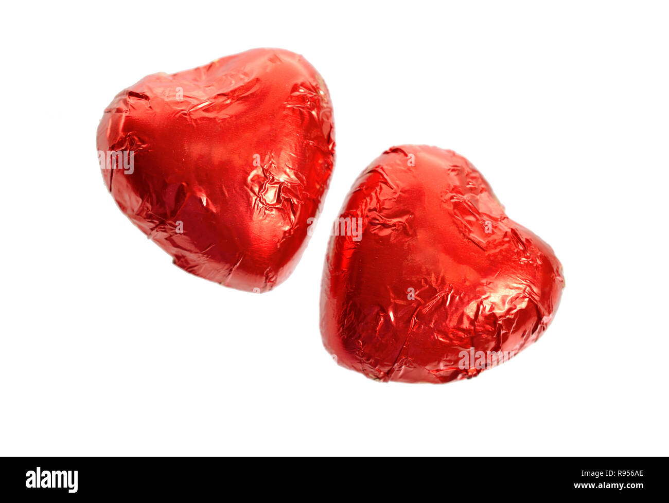 Red Foil wrapped chocolate hearts isolated on white background Stock ...