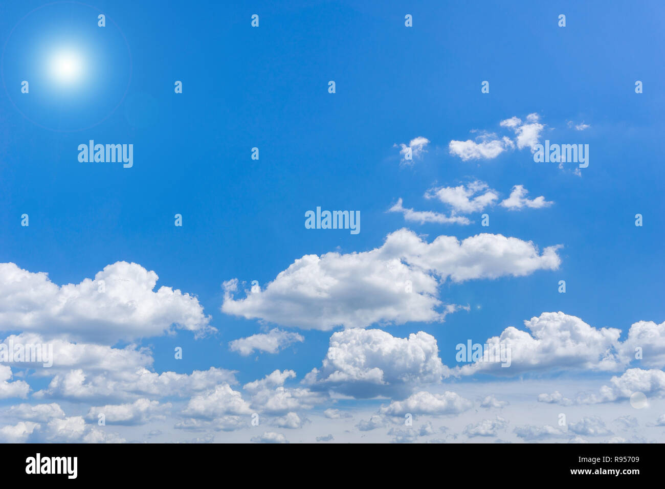 White fluffy clouds and sunshine on in front of blue sky Stock Photo ...