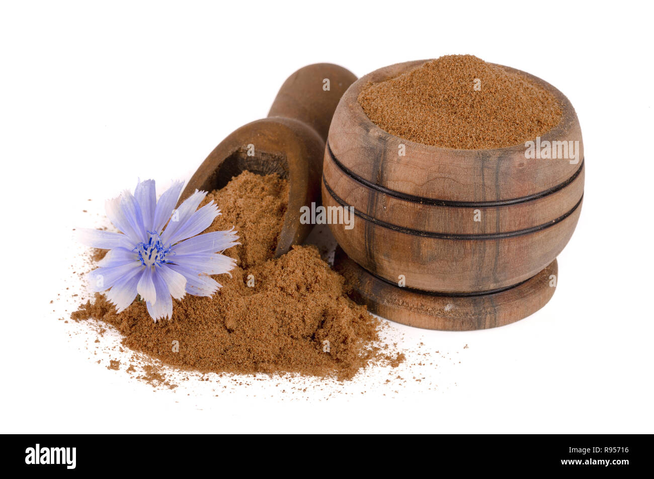 chicory powder in a bowl and scoop with a flower isolated on white ...