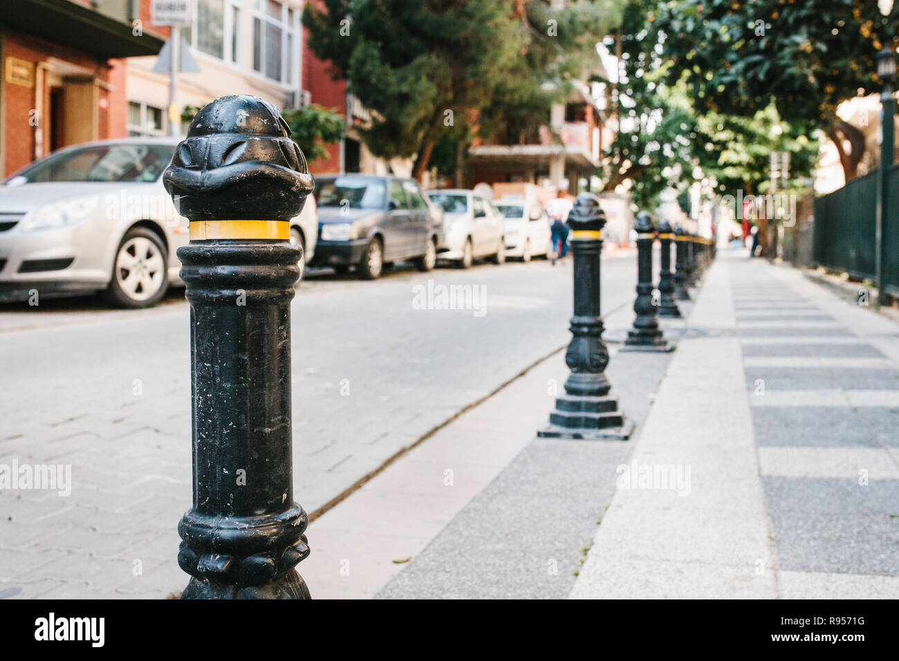 Fencing pillars barriers in a row between the road and the pedestrian ...