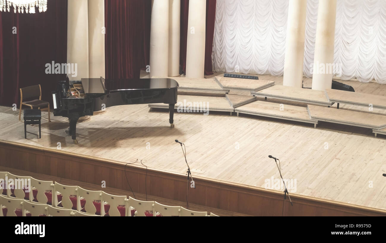 Piano on scene and empty chairs in auditorium of the philharmonic ...