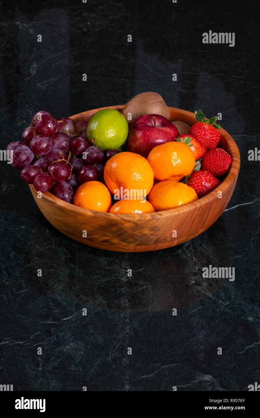 Healthy food: mix from fruits in bowl, old marble background, selective ...