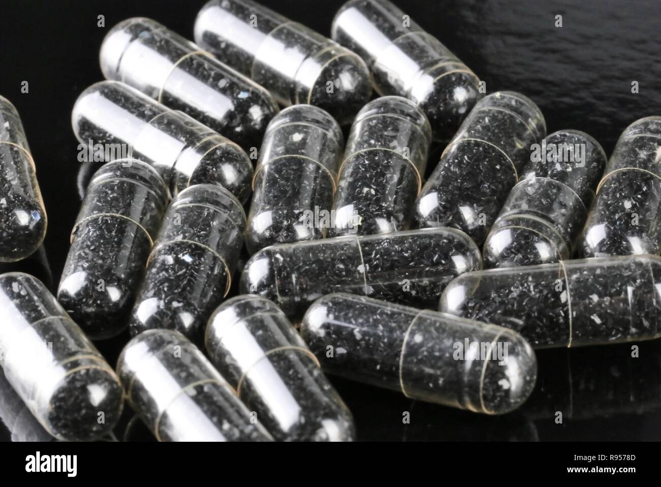 Black glitter capsules Stock Photo - Alamy
