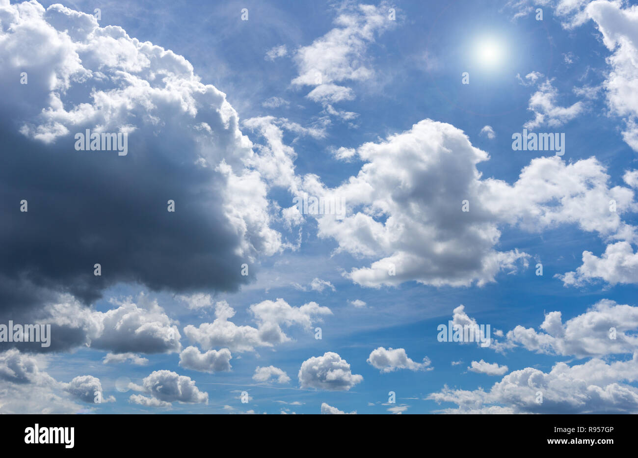 White fluffy clouds and sunshine on in front of blue sky Stock Photo ...