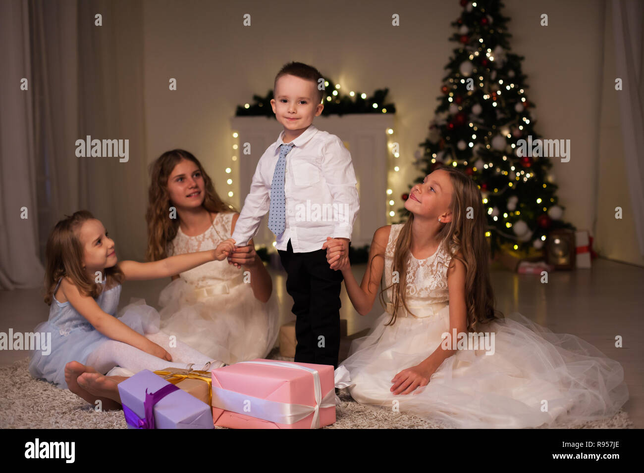 Kids open Christmas New Year holiday lights Christmas tree garlands ...