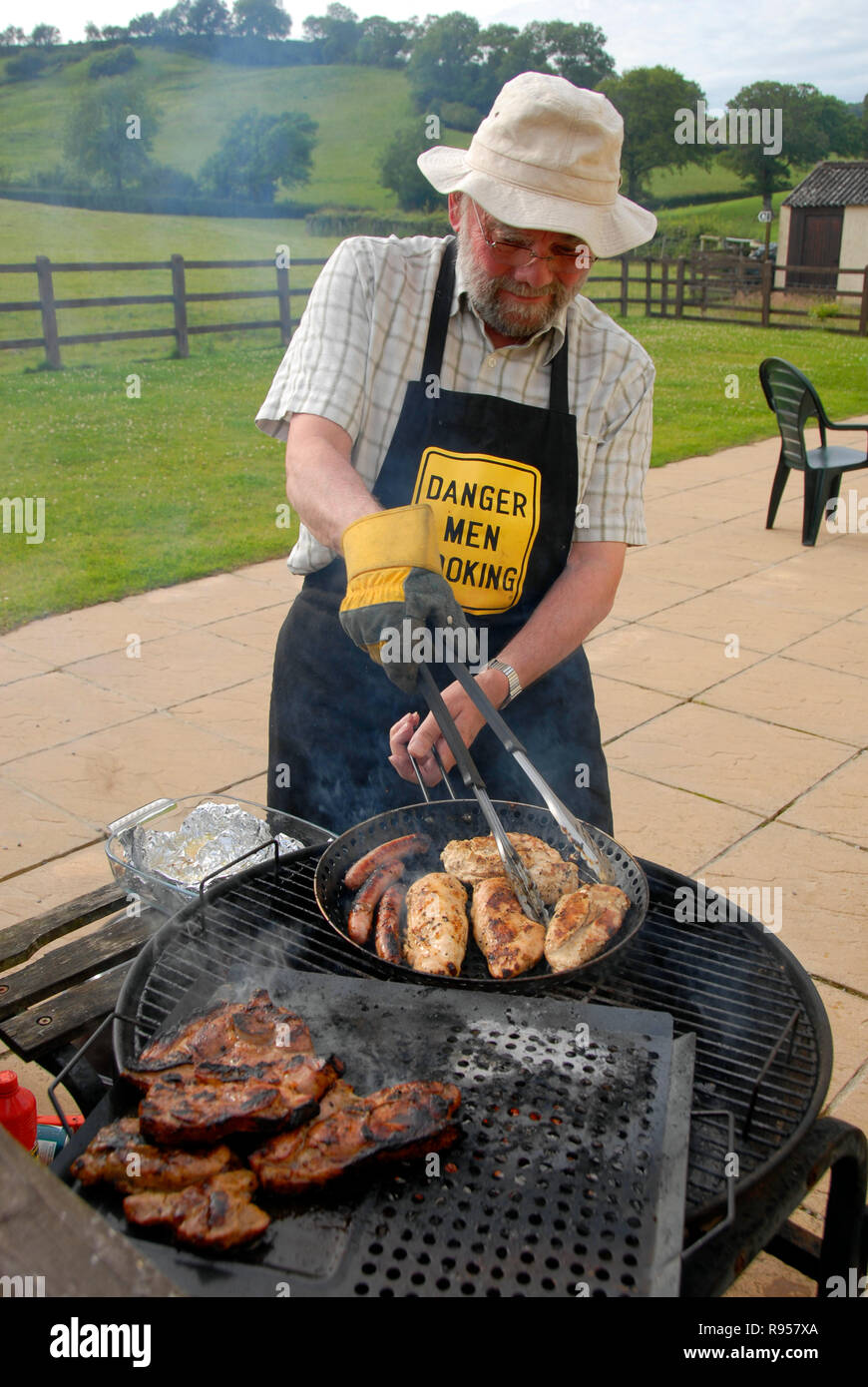 Man cooking meats hi-res stock photography and images - Alamy