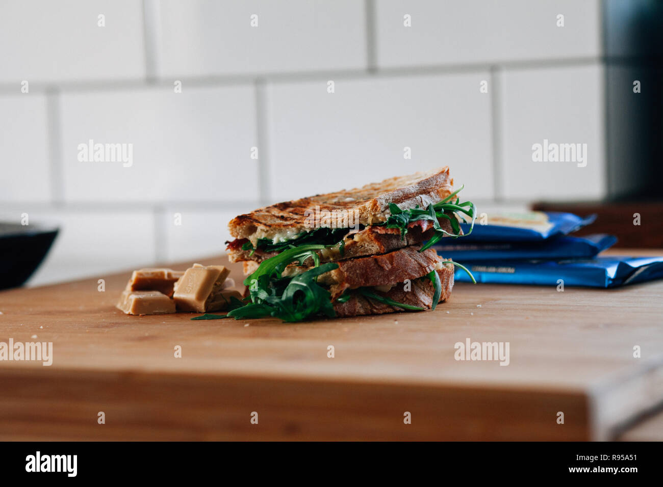 Grilled sandwich with chocolate, bacon and arugula on ructical wooden ...