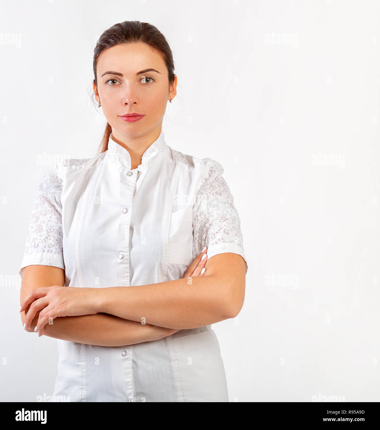Portrait of a beautiful woman in a doctor or beautician costume on a ...