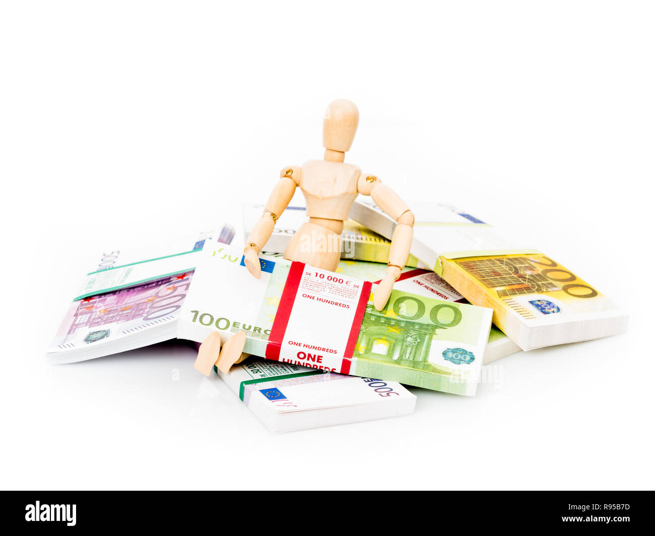 Wooden figurine and euro money Stock Photo - Alamy