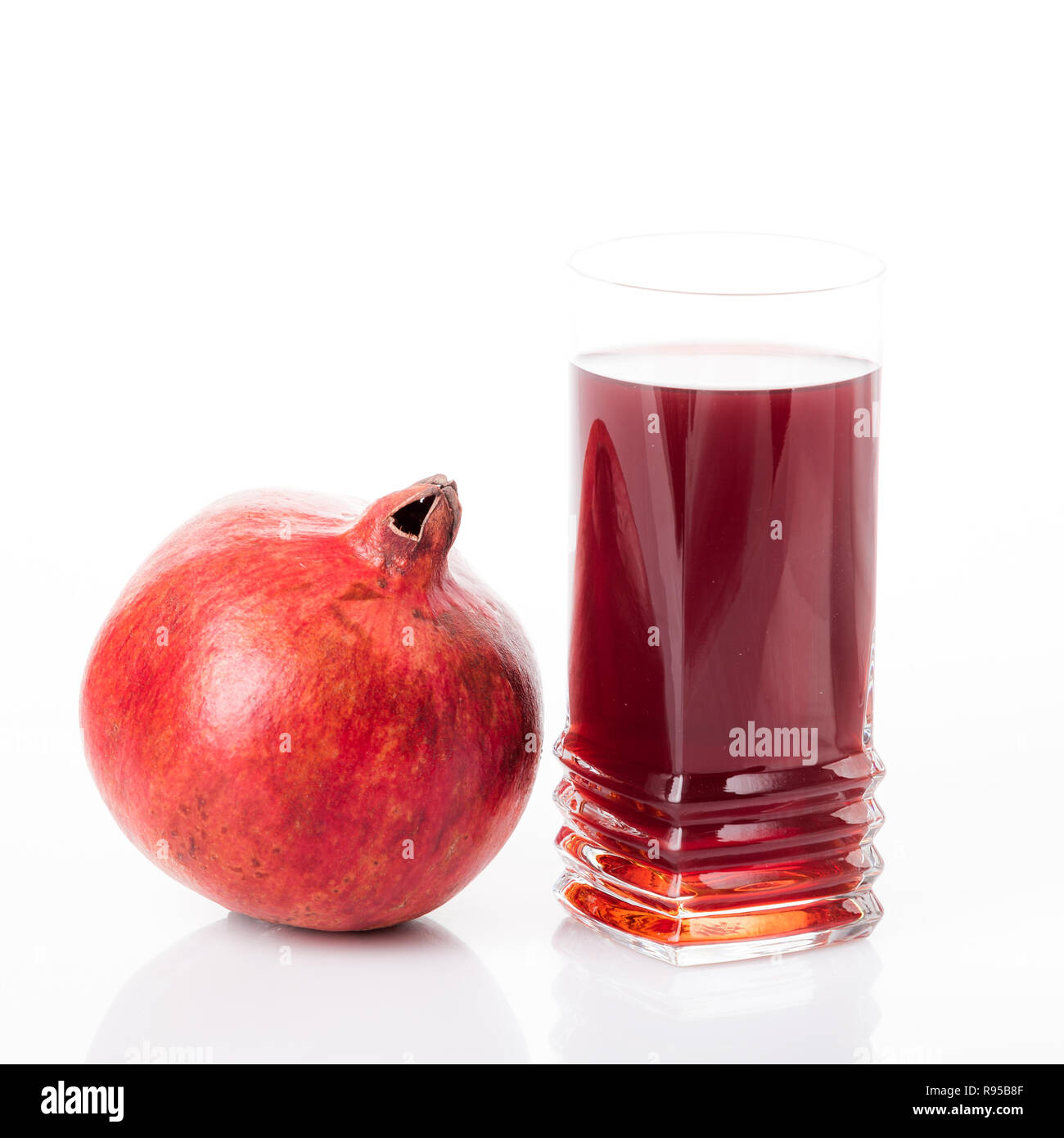 A glass of pomegranate juice with fresh pomegranate fruit Stock Photo ...