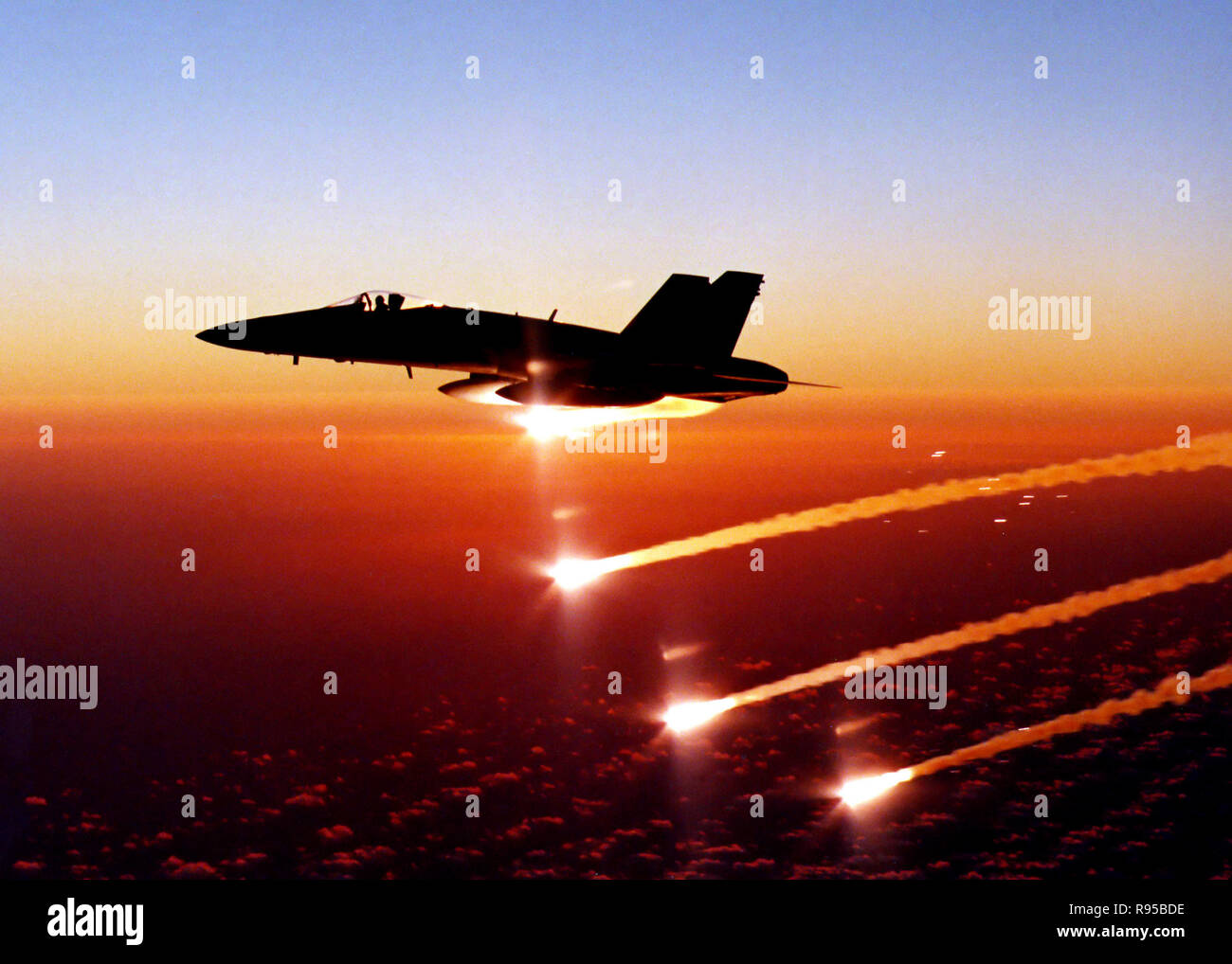 A U.S. Navy F/A-18C Hornet expends flares over the Pacific Ocean. DoD ...