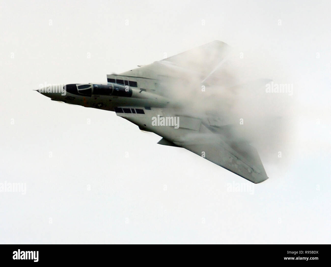 An F-14D Tomcat conducts a high speed flyby causing vapor to form. U.S ...