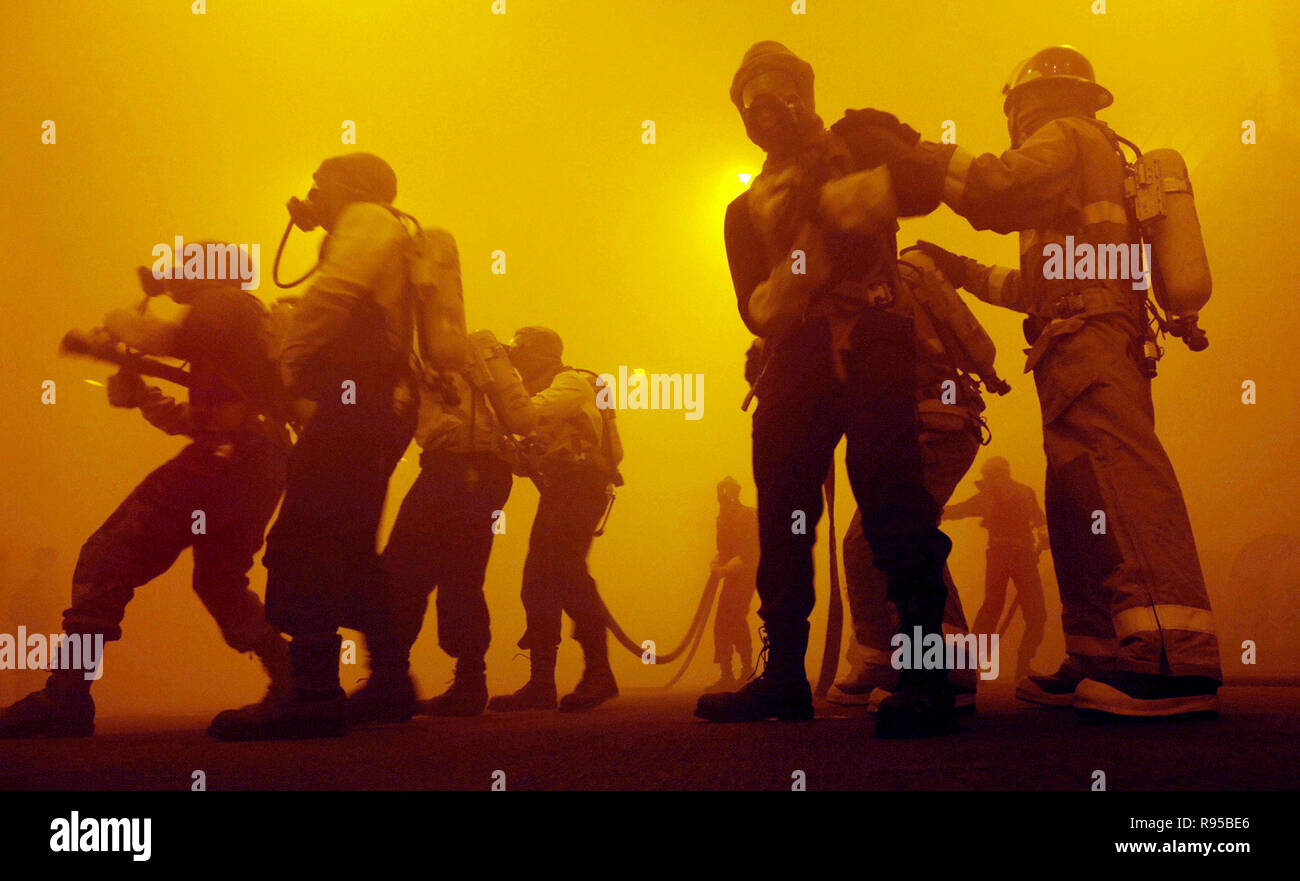 Fire fighting parties work side-by-side while battling a simulated out ...