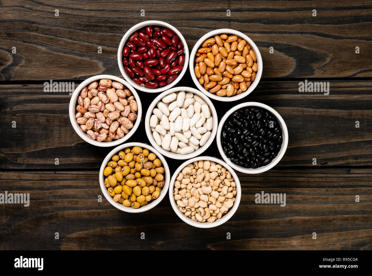 Assortment of beans in a pot. Wooden black background Stock Photo - Alamy