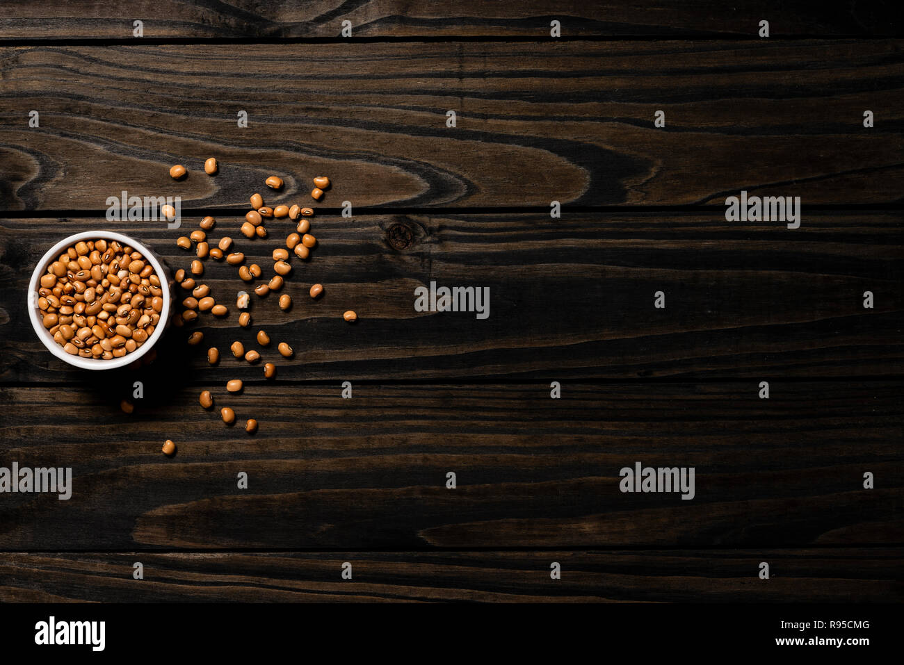Bean ropes in pot. Wooden black background Stock Photo - Alamy