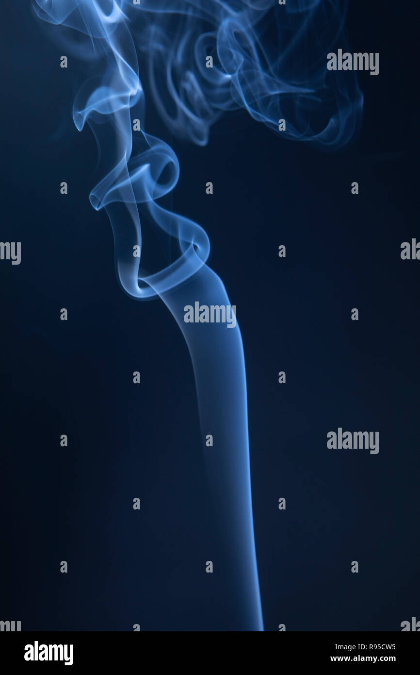 Abstract blue smoke swirls on dark background Stock Photo - Alamy