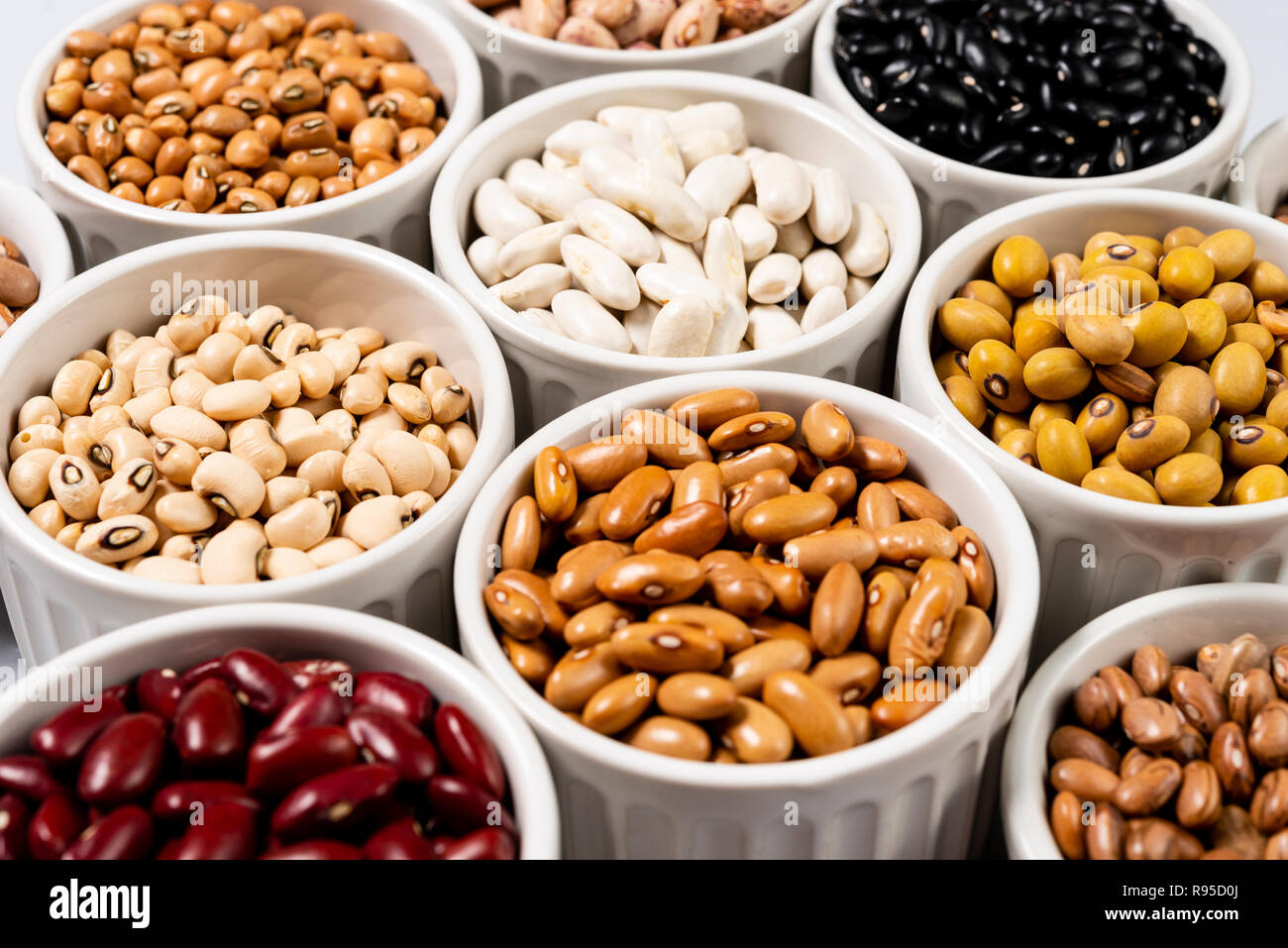 Assortment of beans in pots on gray background Stock Photo - Alamy