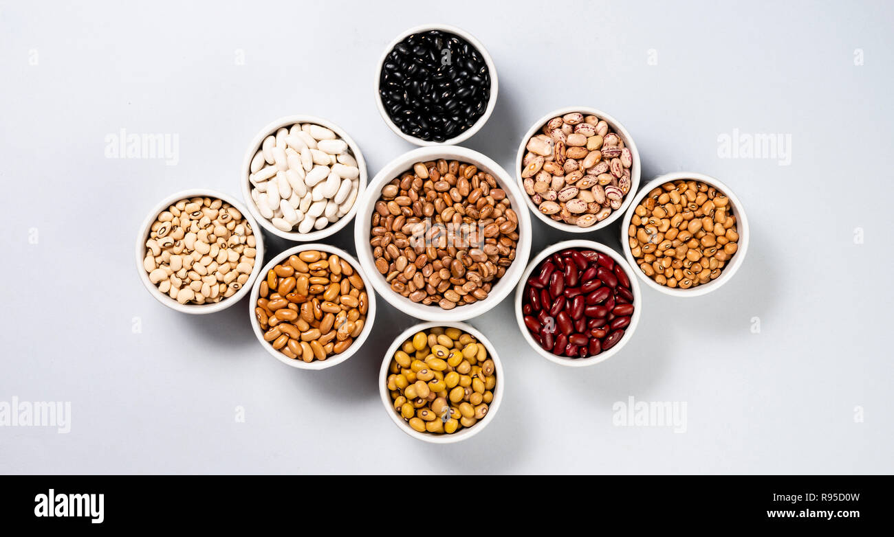 Assortment of beans in pots on gray background Stock Photo - Alamy