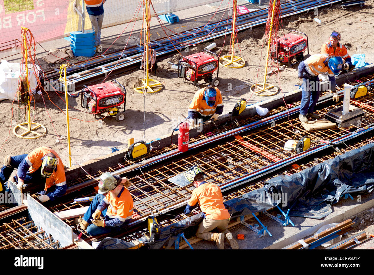 Construction workers building a light rail track for trams in the ...