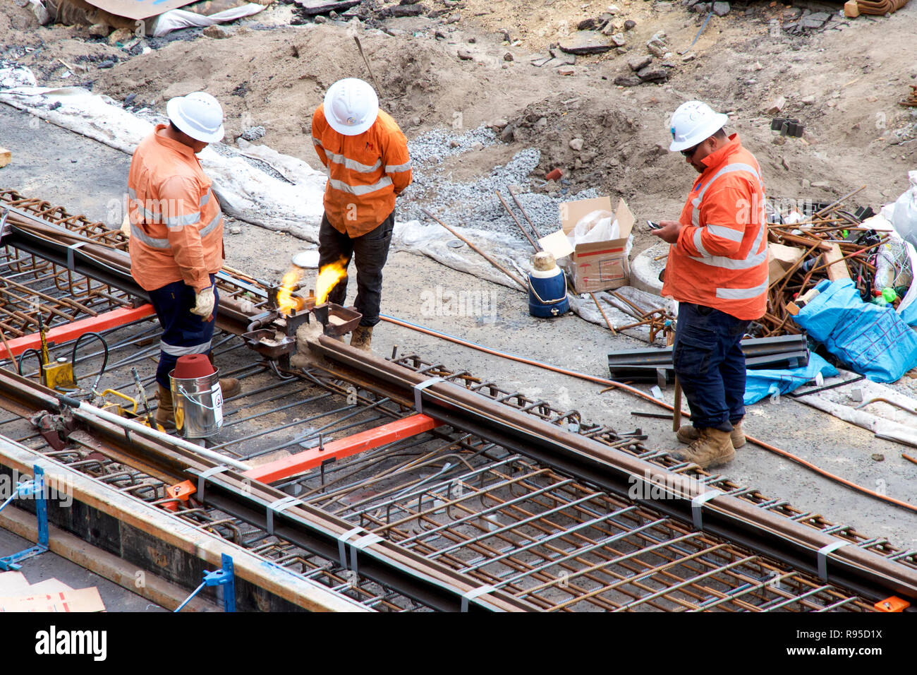 Construction workers building a light rail track for trams in the ...