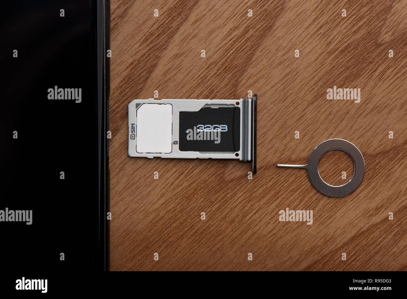 SIM card and microSD card tray with removal tool at the side of ...