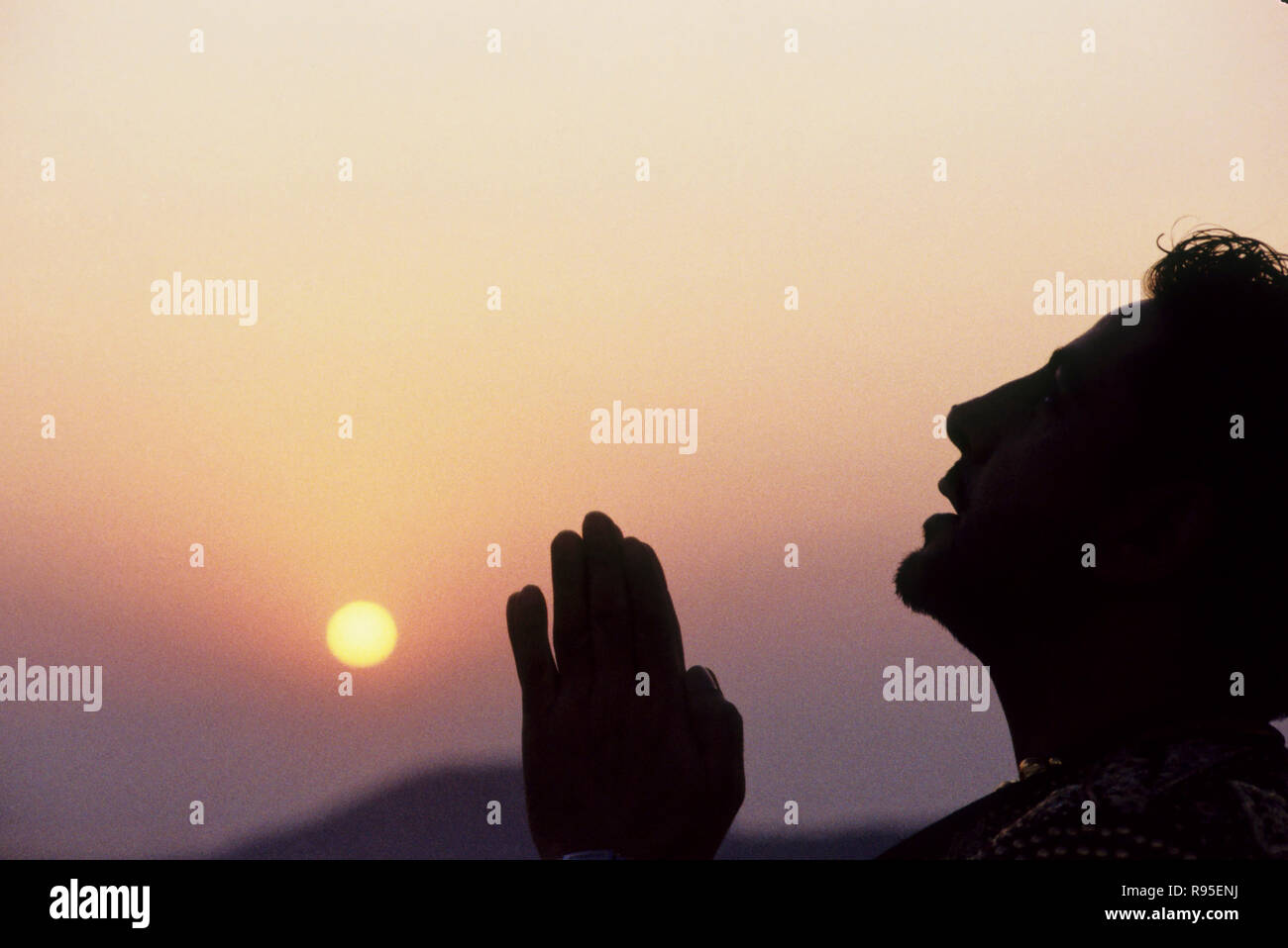 hindu man praying sun at sunrise, india Stock Photo - Alamy