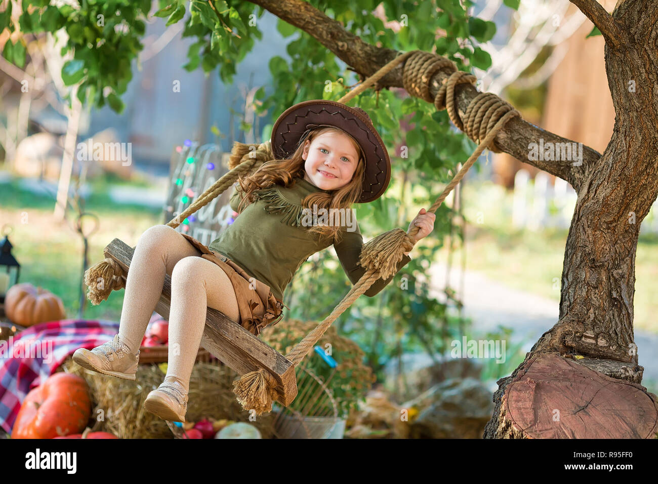 Funny girl child kid in halloween orange costume playing outdoor with ...