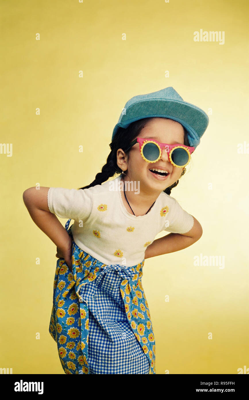 Girl child, wearing cap, funny goggles, hands on hips Stock Photo - Alamy