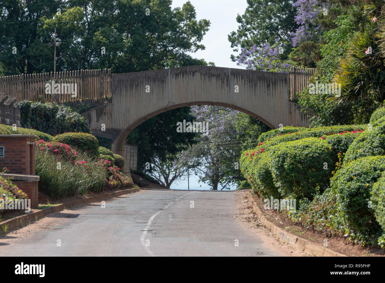 A front side on view of a concrete overhead open bridge going over a ...
