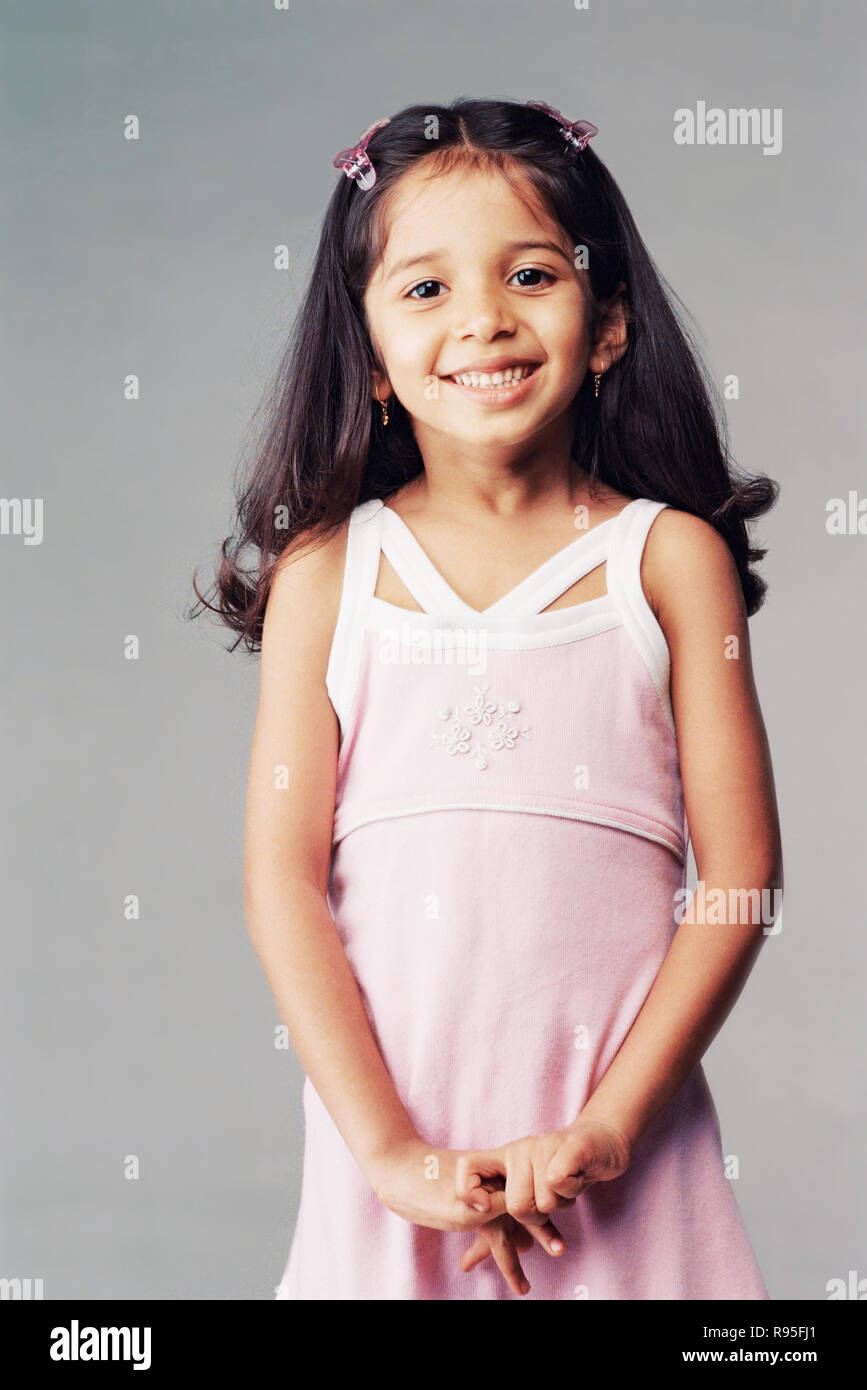 Girl, open hair, standing, looking at camera Stock Photo - Alamy