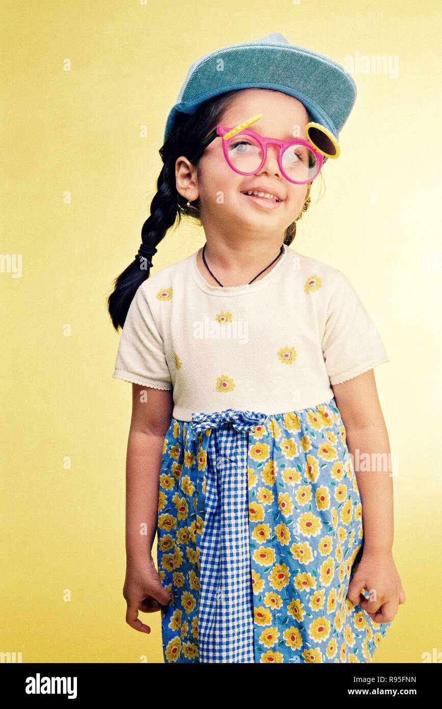Girl child wearing funny glasses and cap Stock Photo - Alamy
