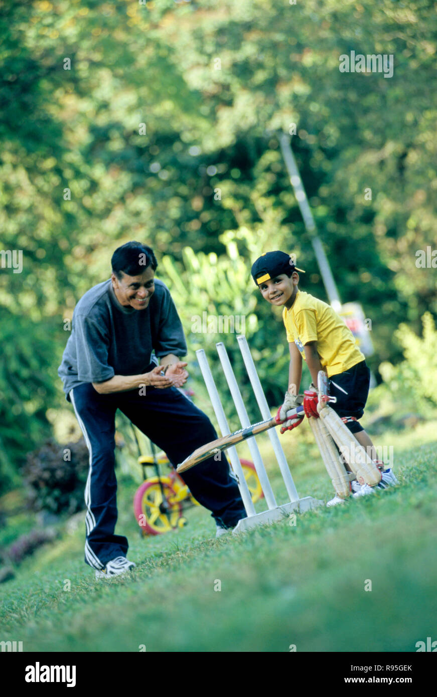 Boy playing cricket father hi-res stock photography and images - Alamy
