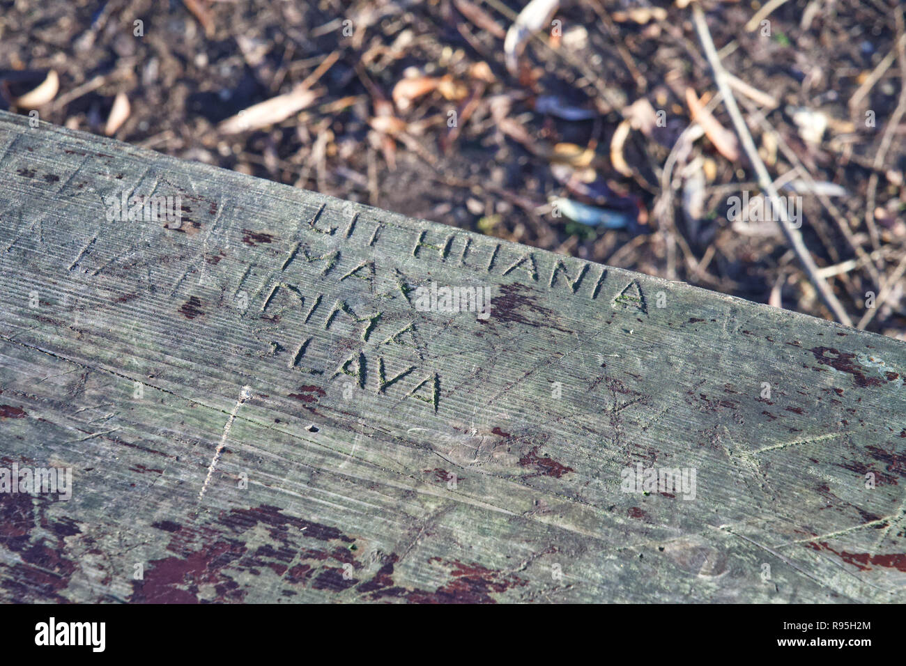 Graffiti on an old wooden bench Stock Photo - Alamy