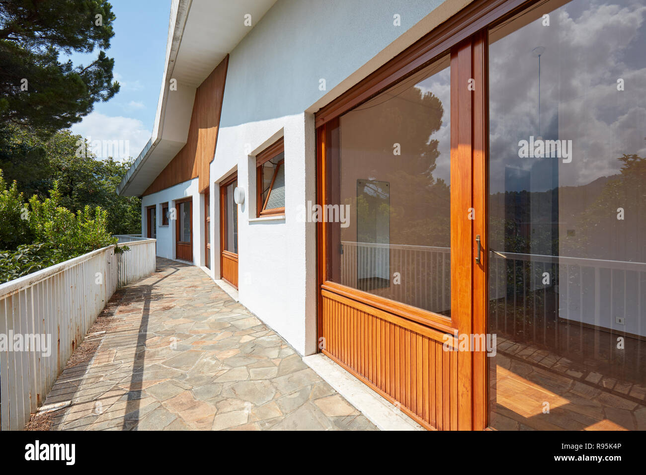 Large terrace and room interior in sunny country house Stock Photo - Alamy