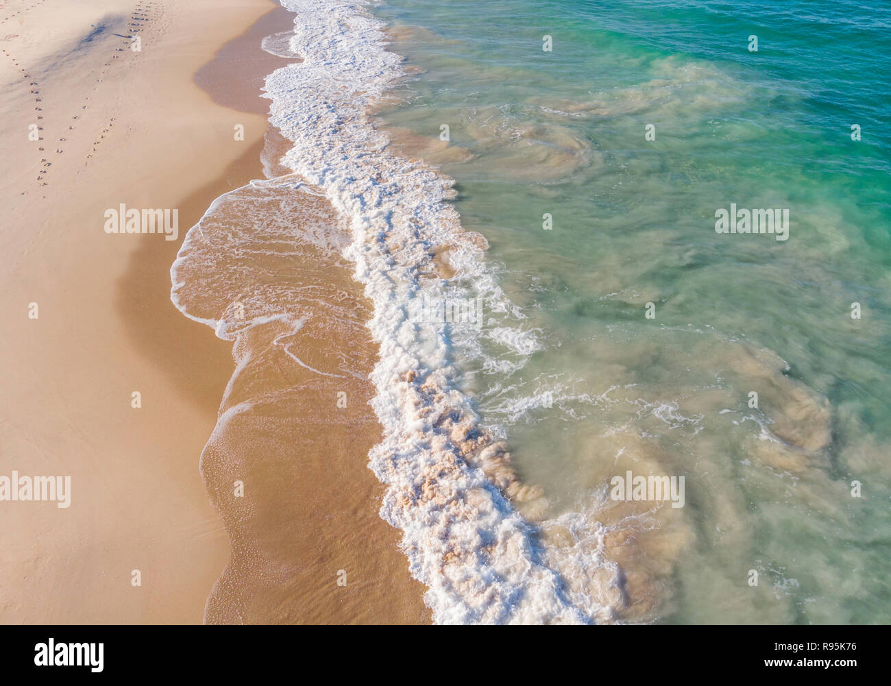An aerial view of waves breaking onto the sand at City Beach in Perth ...