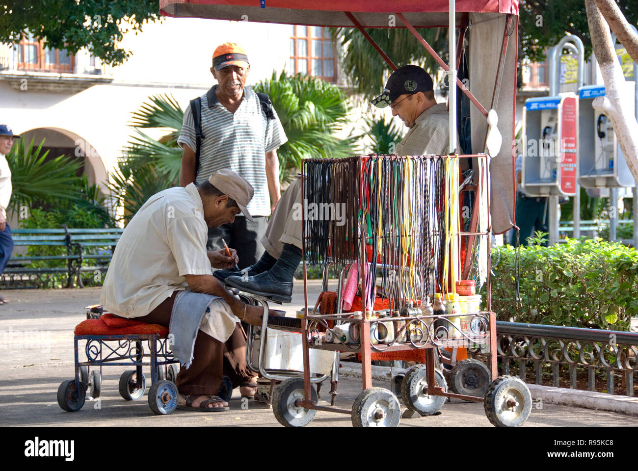 Merida, Mexico – Jan 16 2007: Three men catch up on on the news over a ...