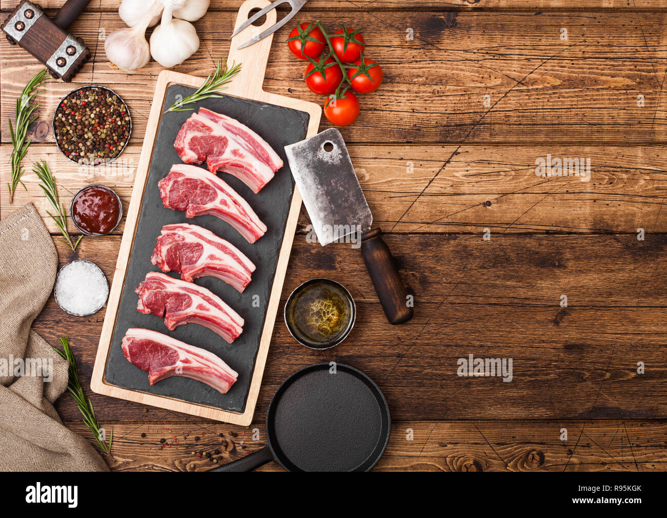 Fresh raw butchers lamb beef cutlets on chopping board with vintage ...