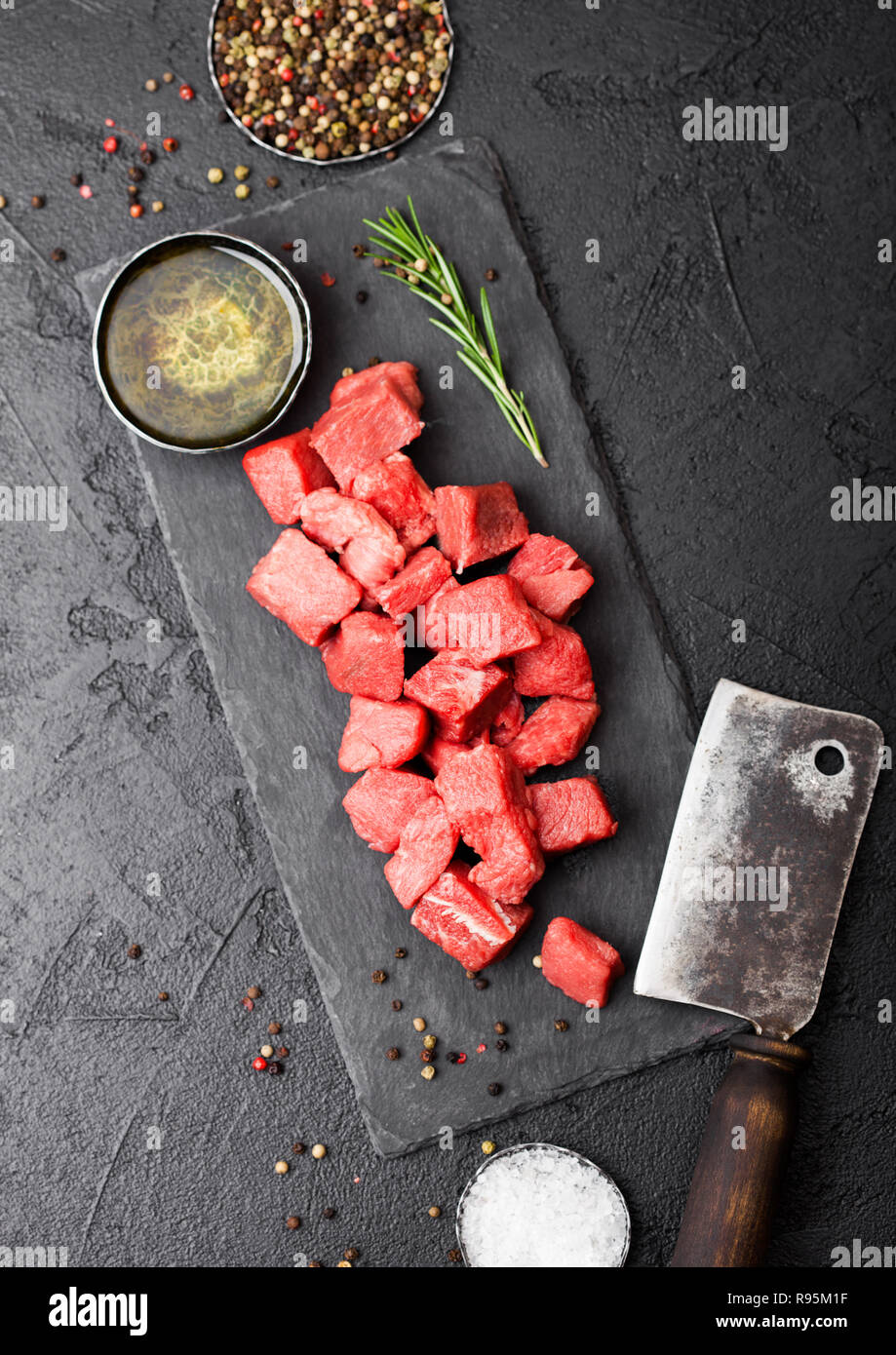 Raw lean diced casserole beef pork steak on chopping board with vintage ...