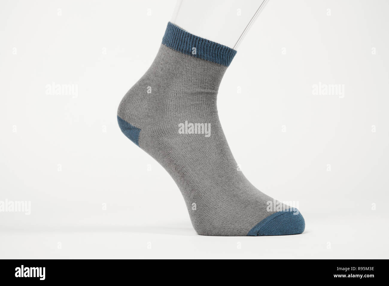 Transparent foot with a sock. Advertising of the product on the white ...