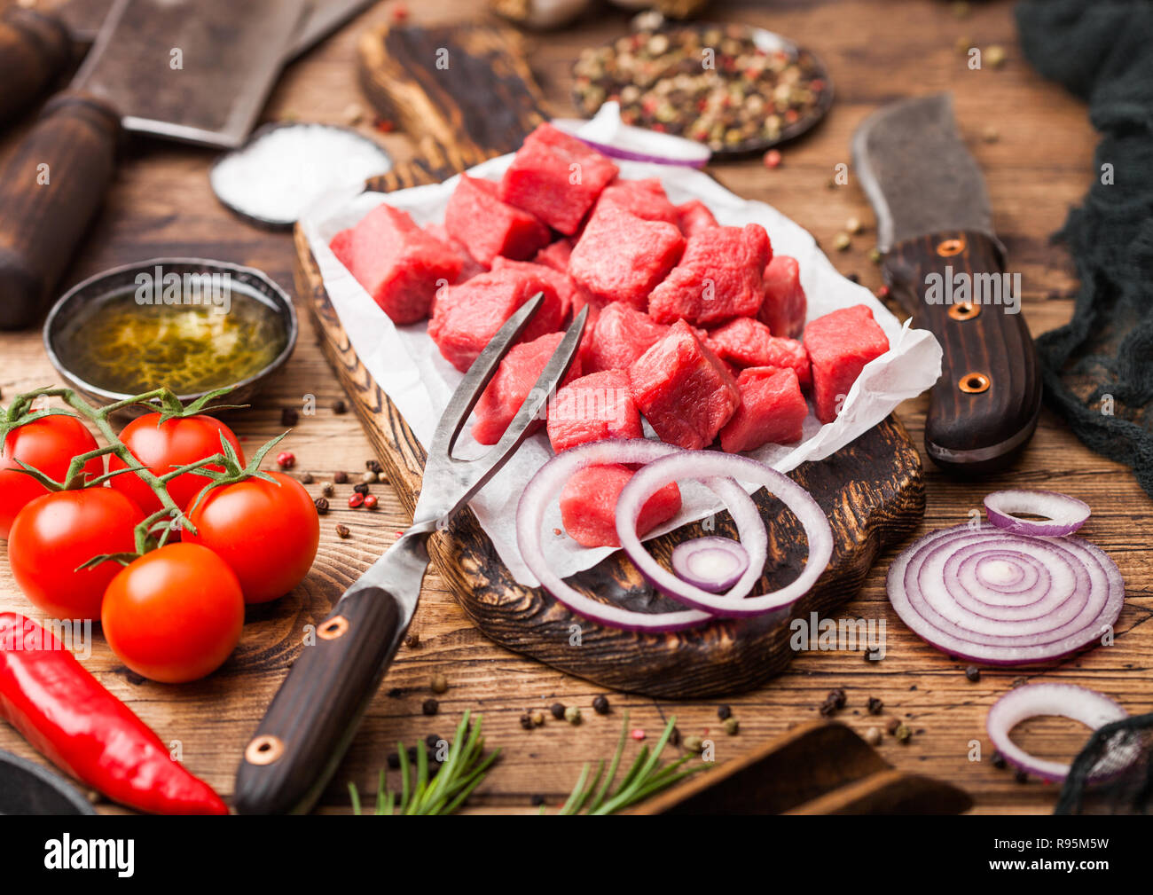 Raw lean diced casserole beef pork steak with vintage meat hatchet and ...