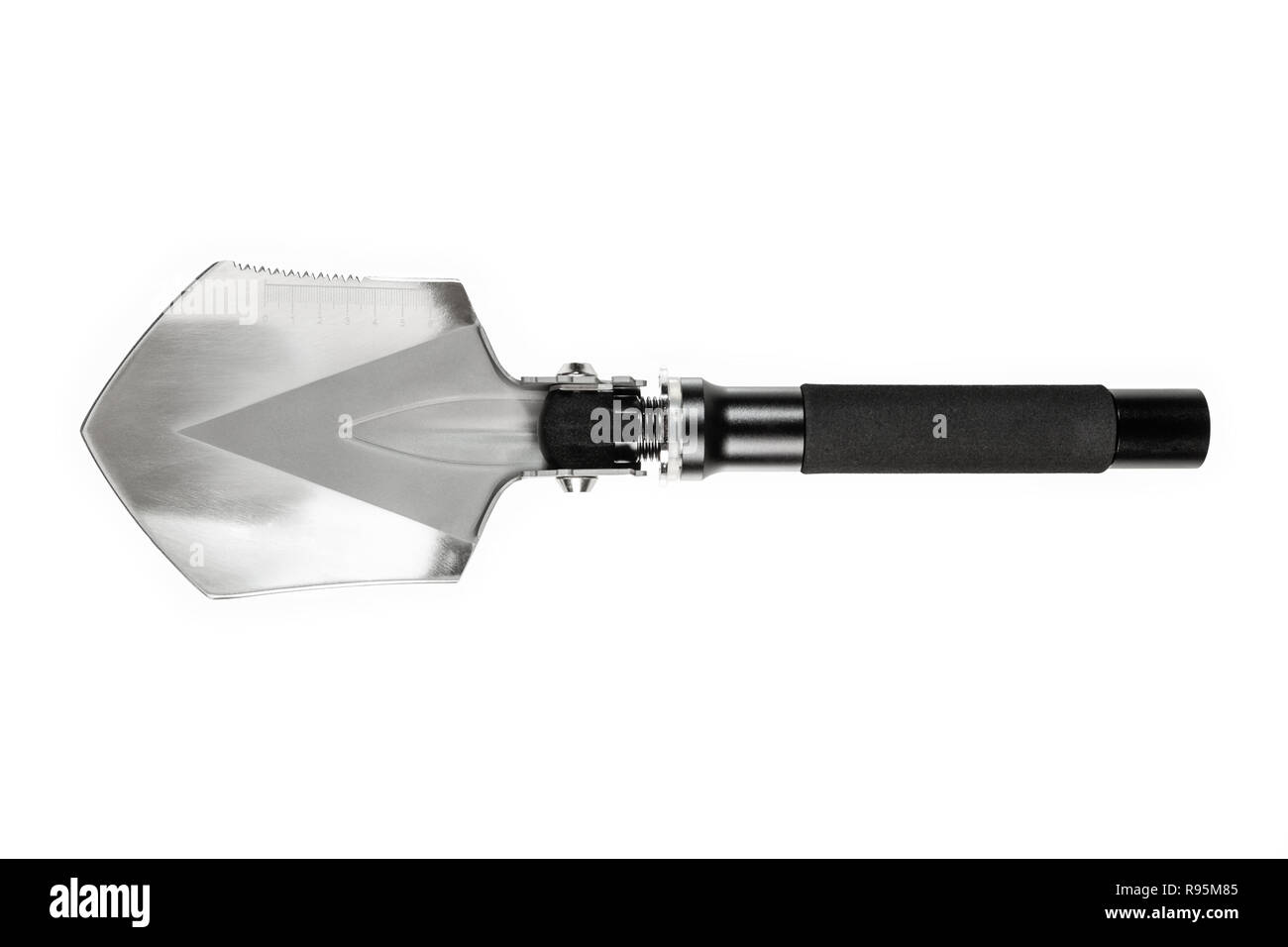 Sharp metal shovel with a saw on white background. Isolated Stock Photo ...