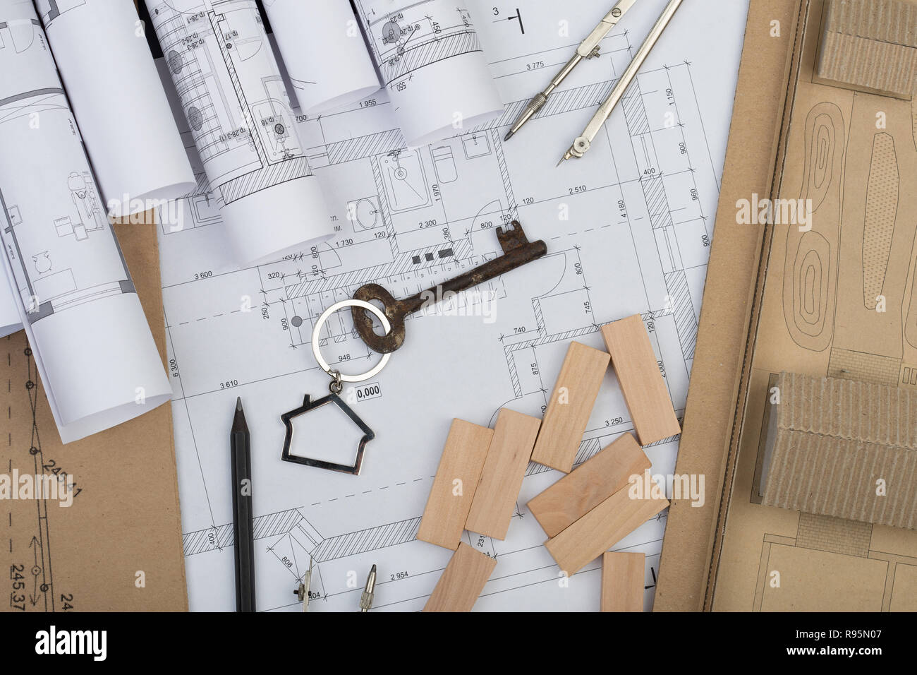 Workplace of architect - key with trinket in the shape of a house ...