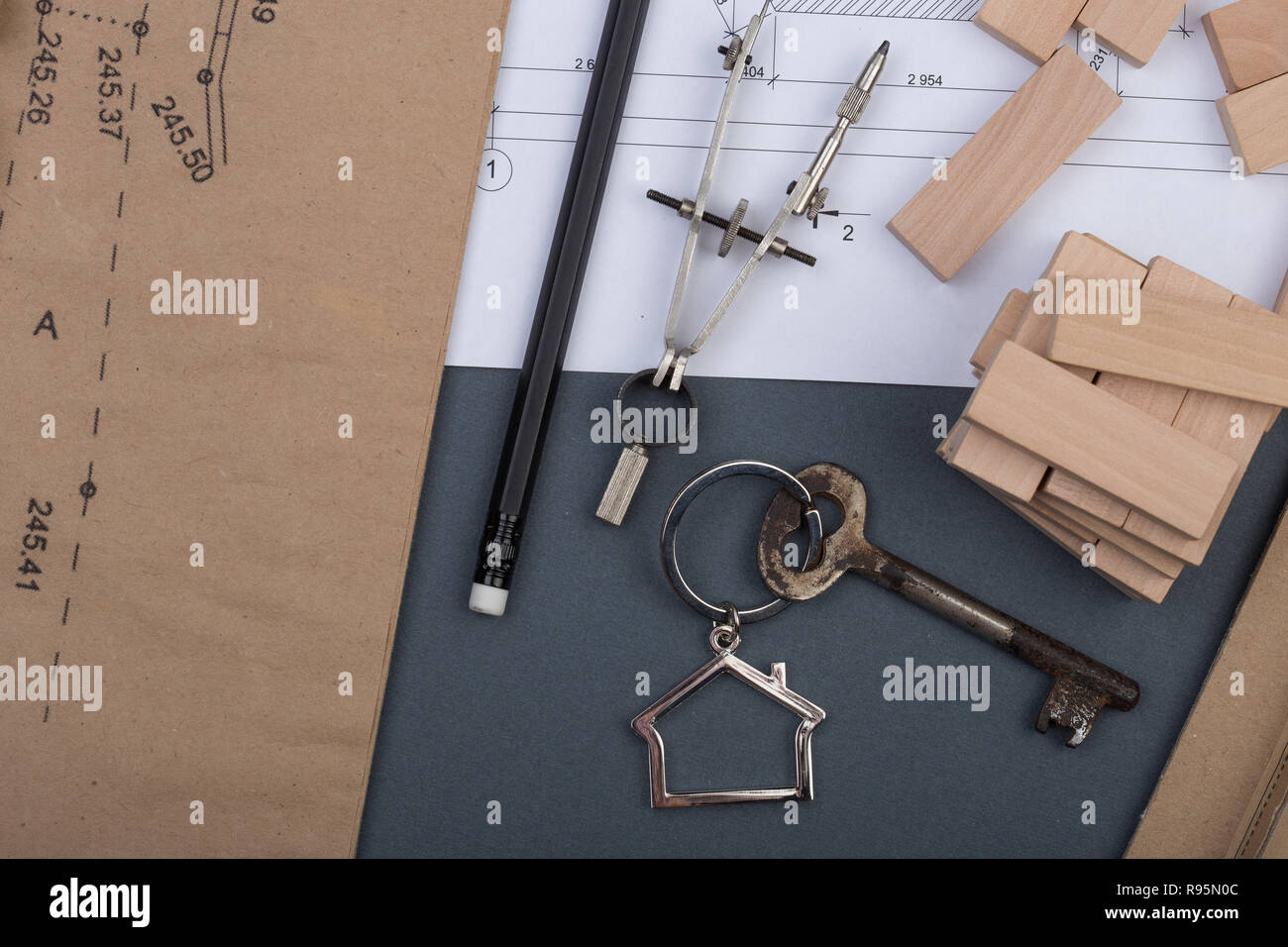 Workplace of architect - key with trinket in the shape of a house ...