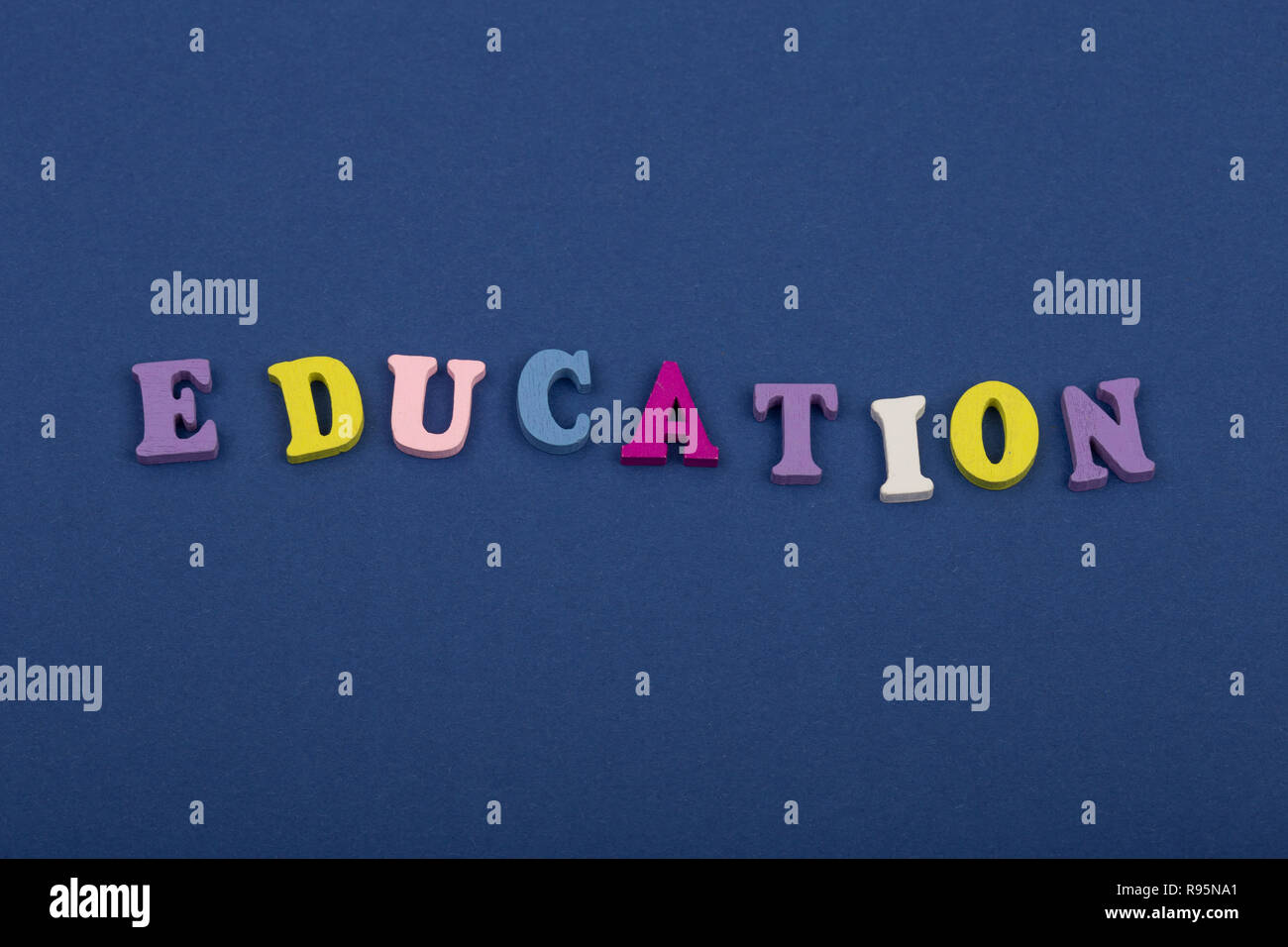 Education concept - text "Education" of wooden letters on blue ...