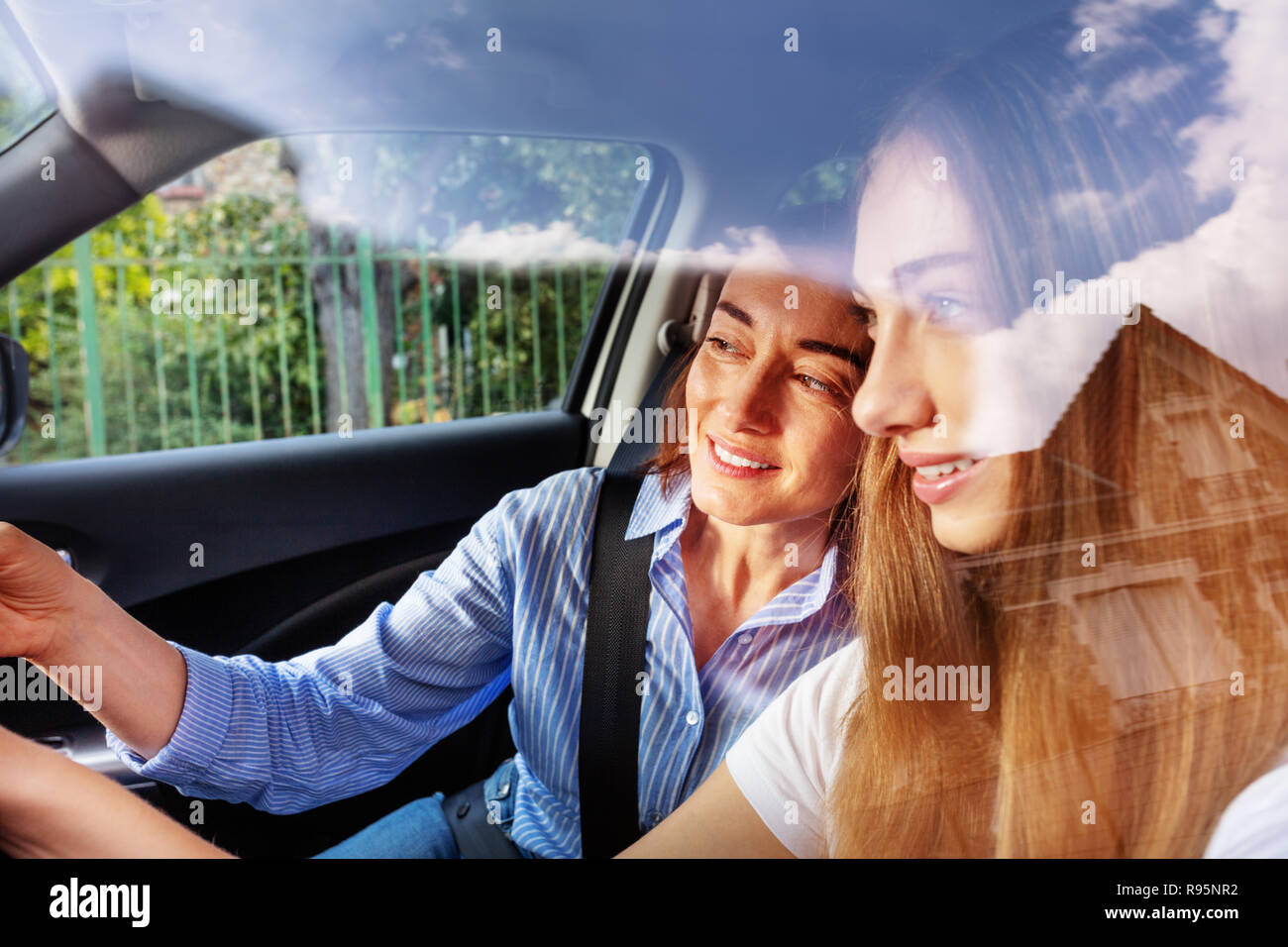 Mother driving car, daughter passenger hi-res stock photography and ...