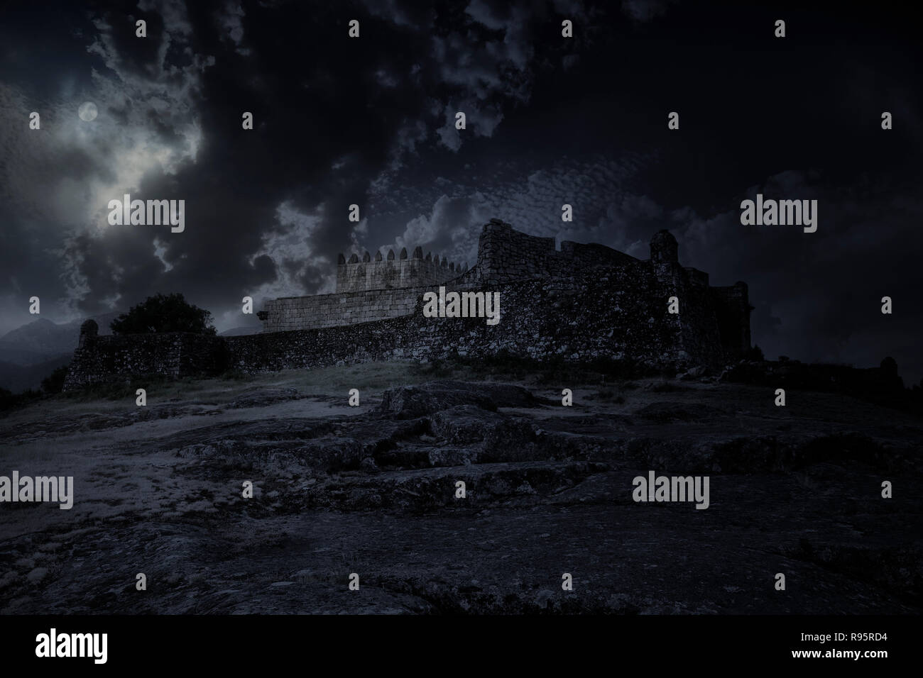 Medieval castle in a cloudy and dark full moon night Stock Photo - Alamy